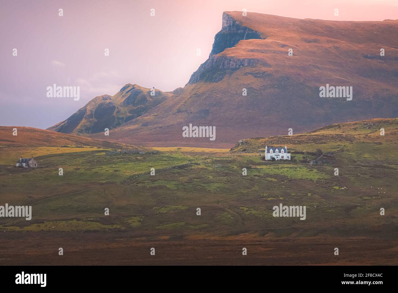 Dramatic countryside mountain landscape at sunset or sunrise of a lone ...
