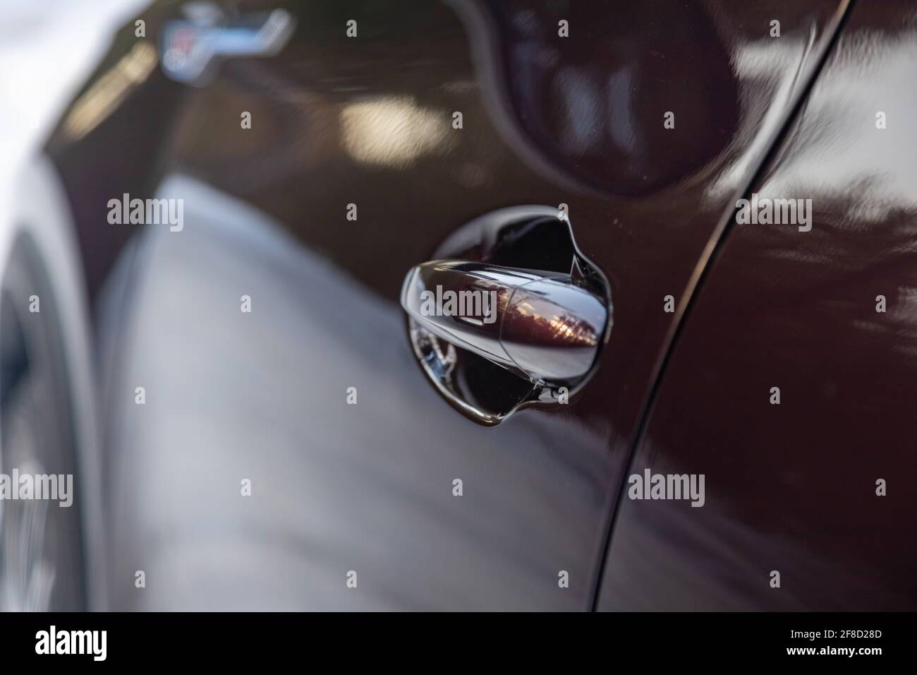 car door handle with keyless enrty system. the car body is dark in ...