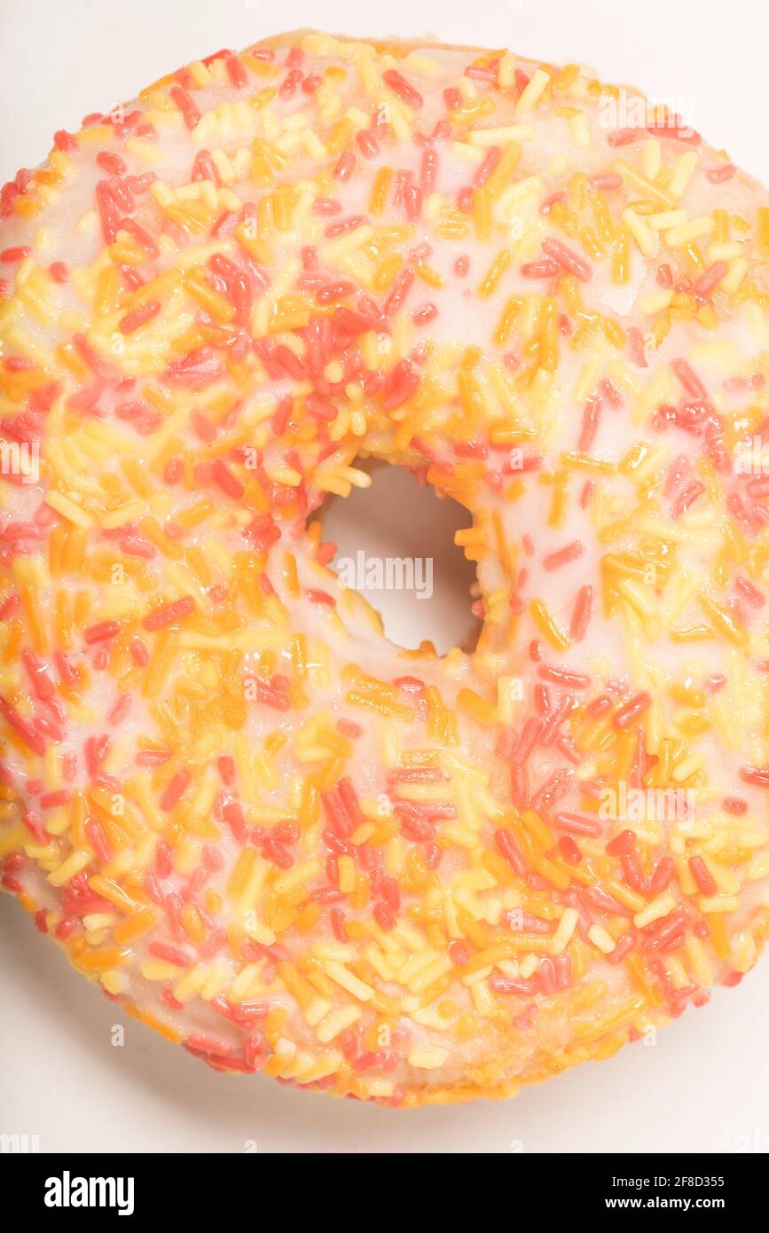 Close up of a colourful iced ring doughnut with sprinkles Stock Photo ...