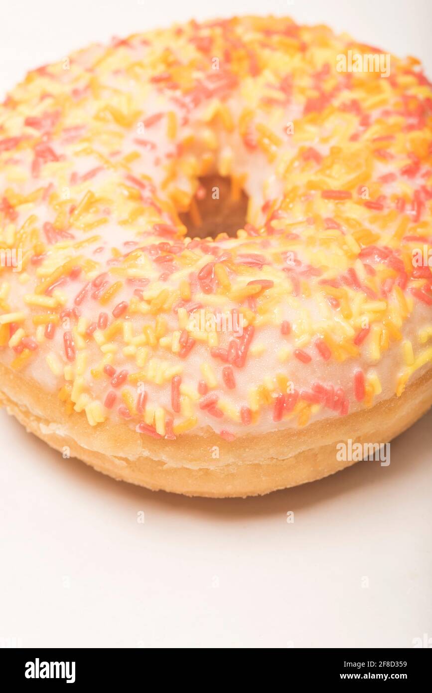 Colourful iced ring doughnuts with sprinkles Stock Photo - Alamy