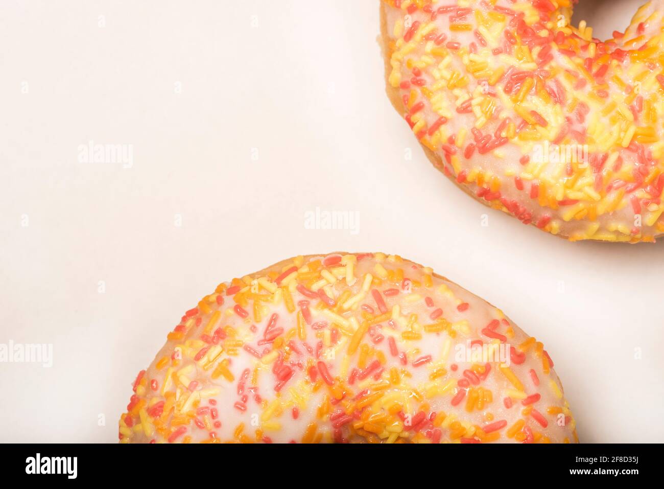 Colourful iced ring doughnuts with sprinkles Stock Photo - Alamy