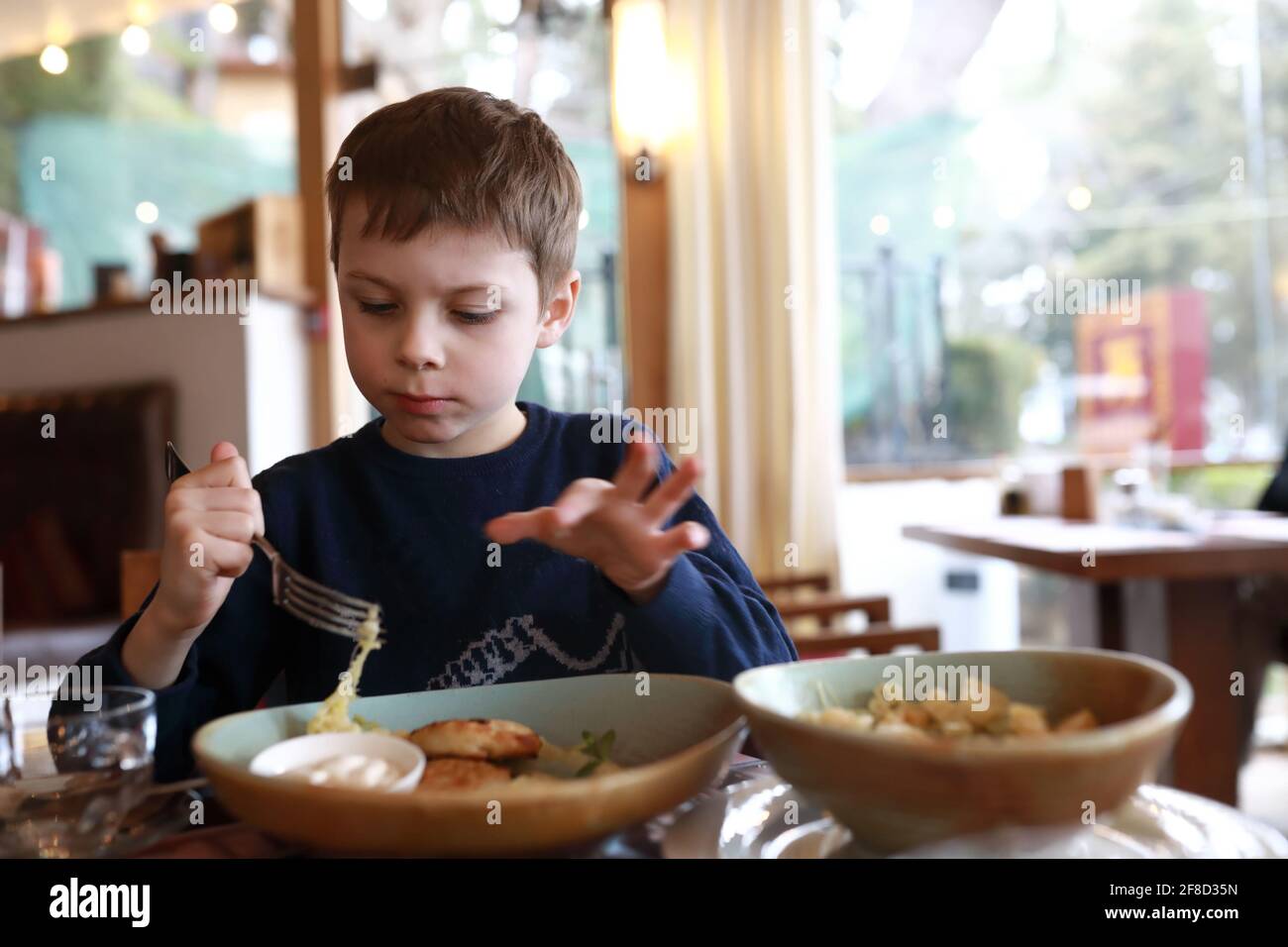 Kid eating pasta cheese hi-res stock photography and images - Alamy