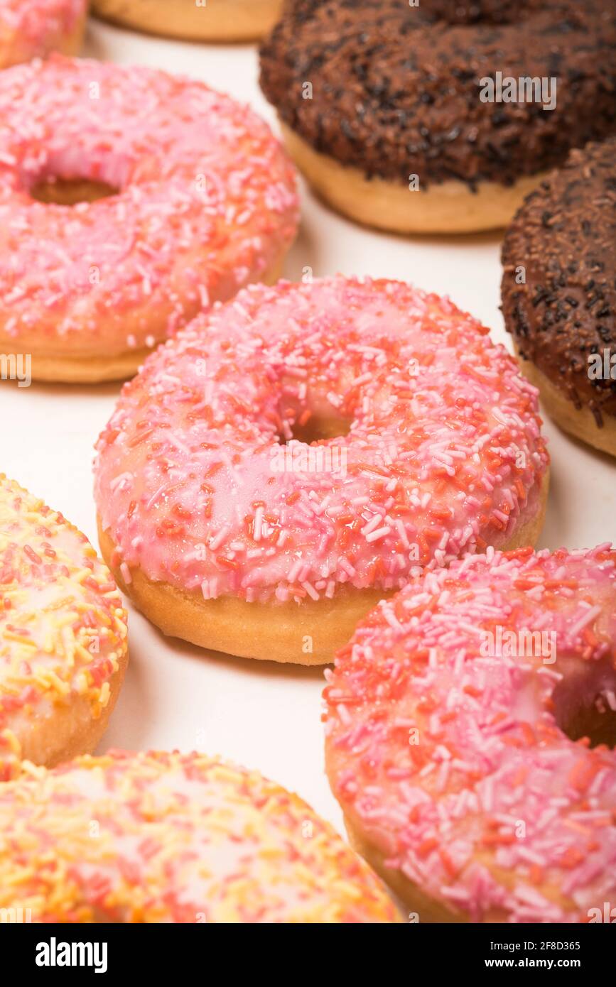 Colourful iced ring doughnuts with sprinkles Stock Photo - Alamy