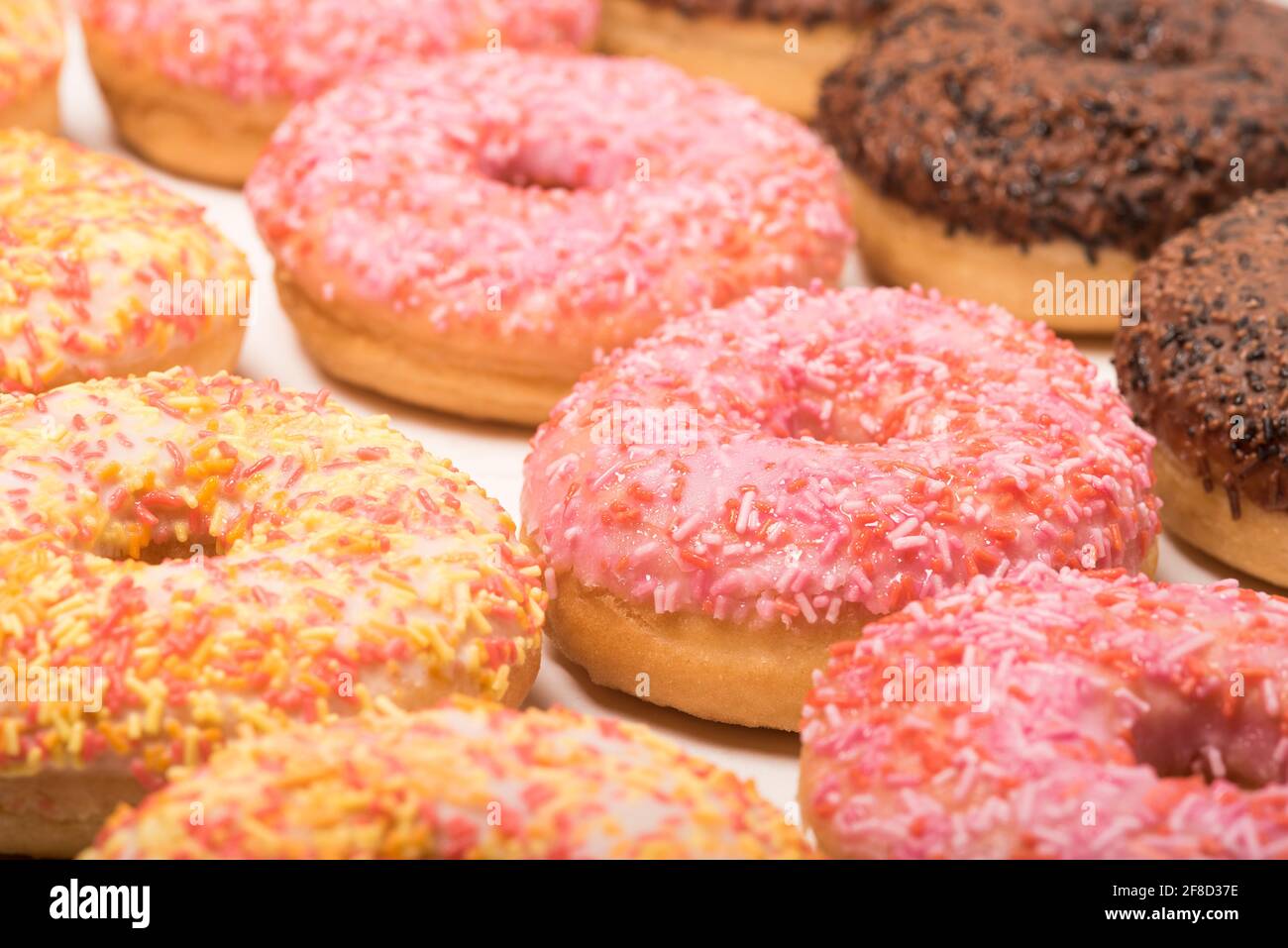 Colourful iced ring doughnuts with sprinkles Stock Photo - Alamy