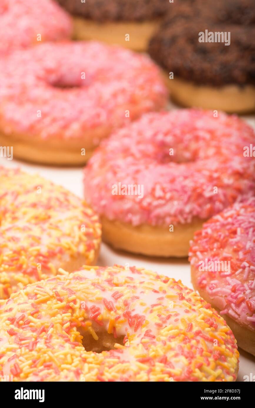 Colourful iced ring doughnuts with sprinkles Stock Photo - Alamy