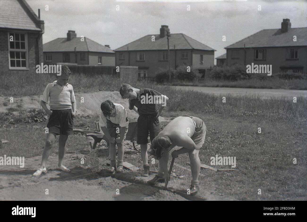 1963, historical, summertime and standing on a empty plot of land on a ...