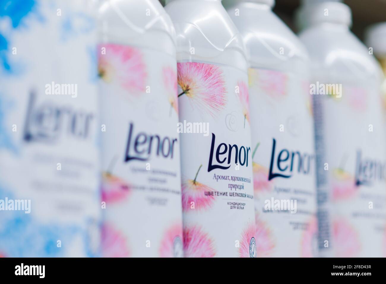 An assortment of washing powders of different brands on shelves in the ...