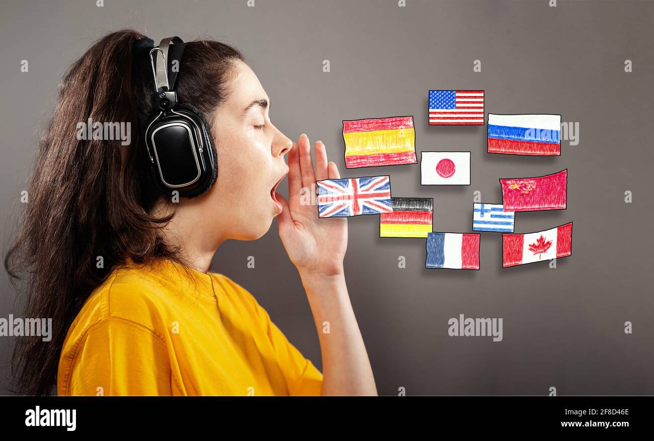 Online language learning. Portrait of a young woman wearing headphones ...