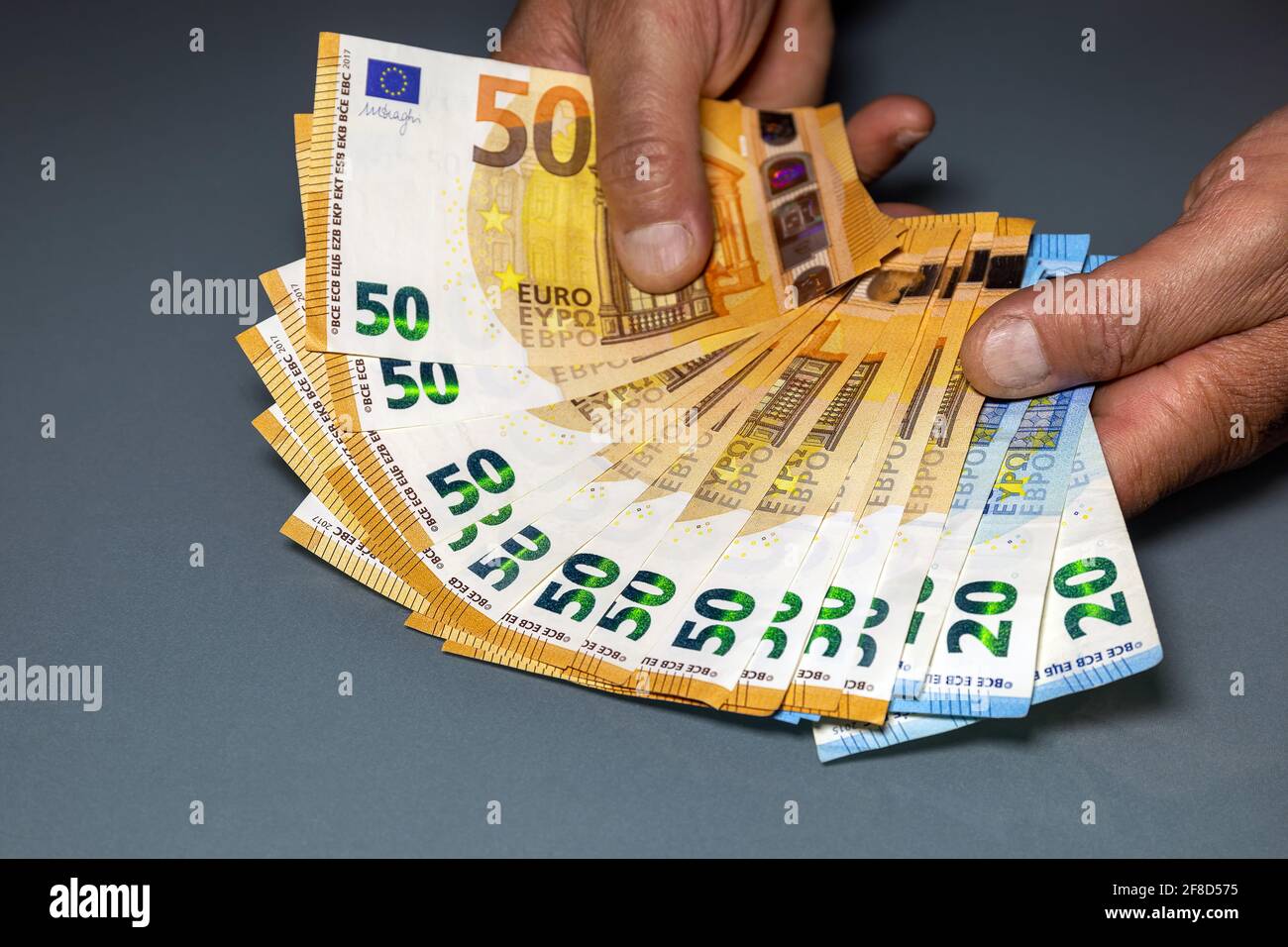 Series of banknotes arranged in a fan shape on the table. Cash, 50 euro ...