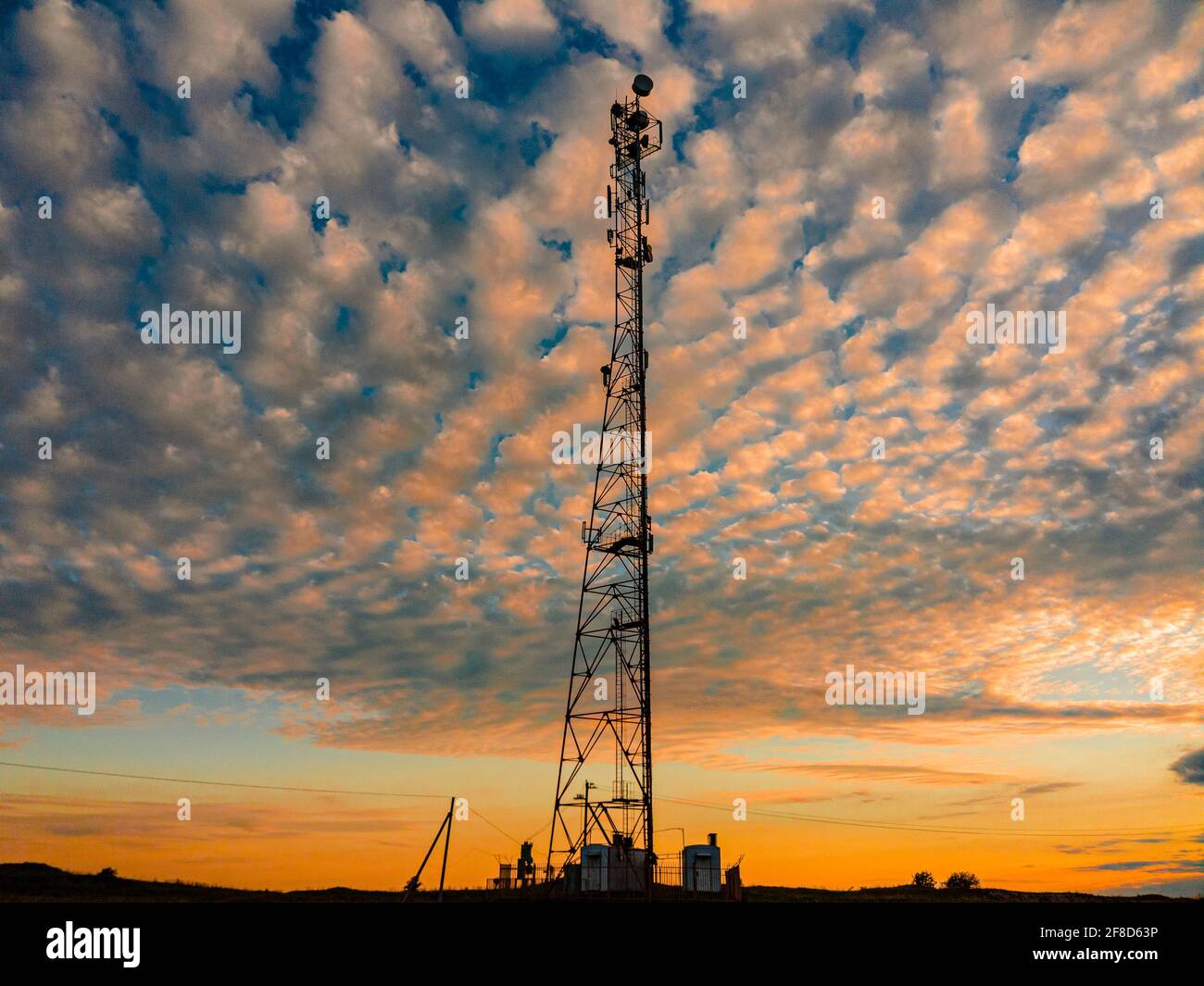High mobile tower and evening sky with beautiful clouds Stock Photo - Alamy
