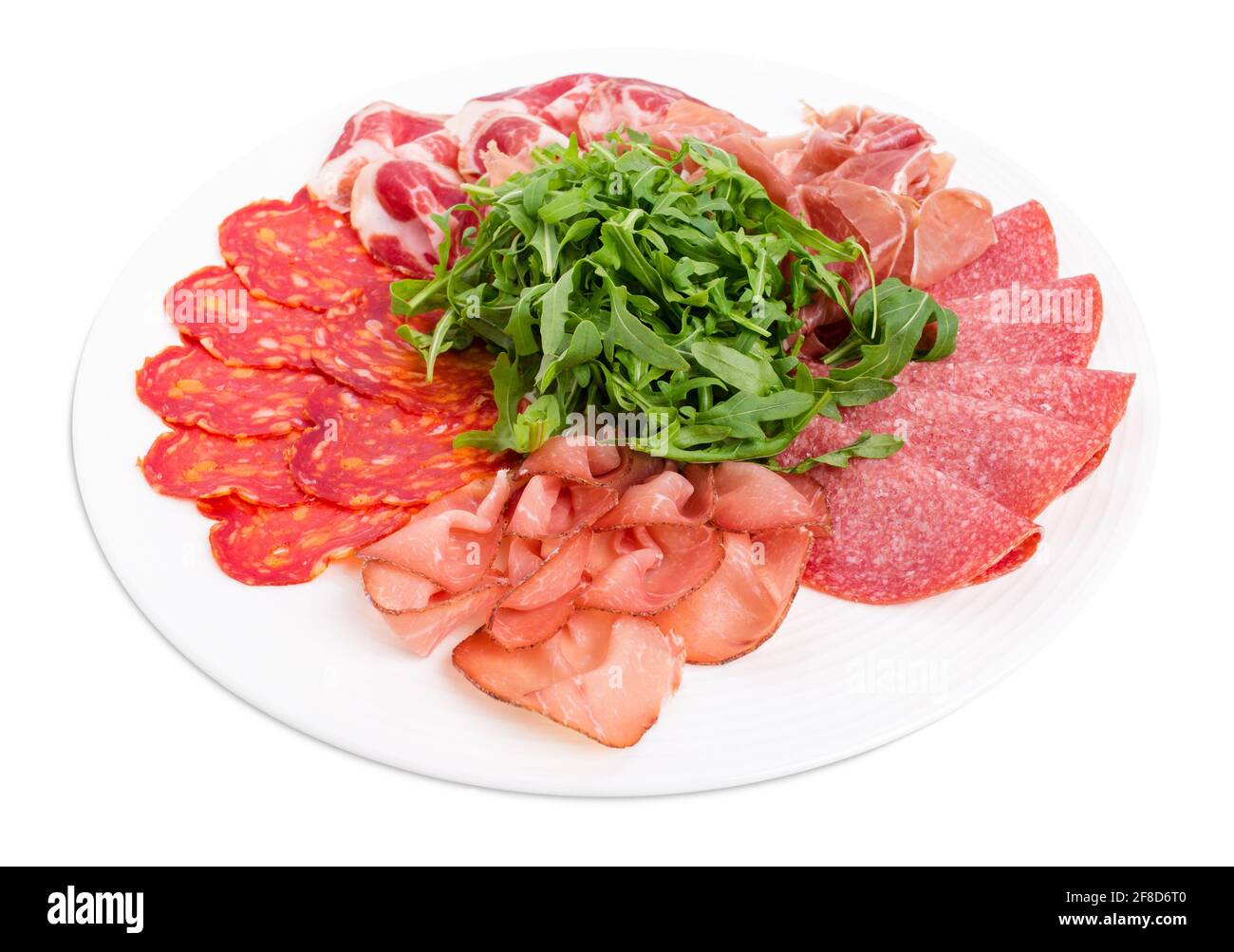 Delicious italian dried meat platter with heap of arugula. Isolated on ...