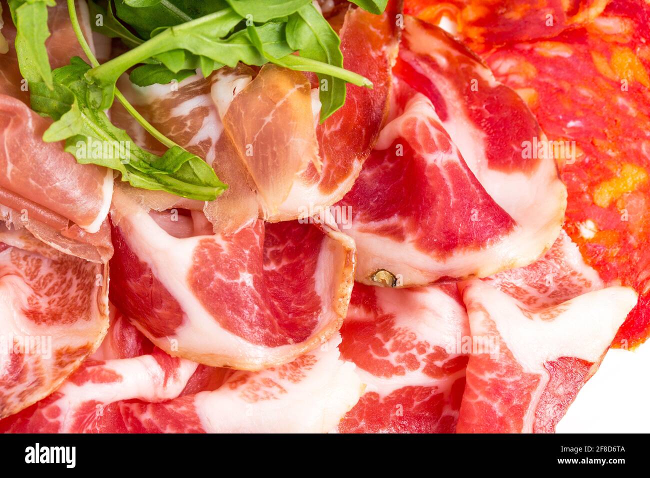Delicious italian dried meat with heap of arugula. Macro. Photo can be ...