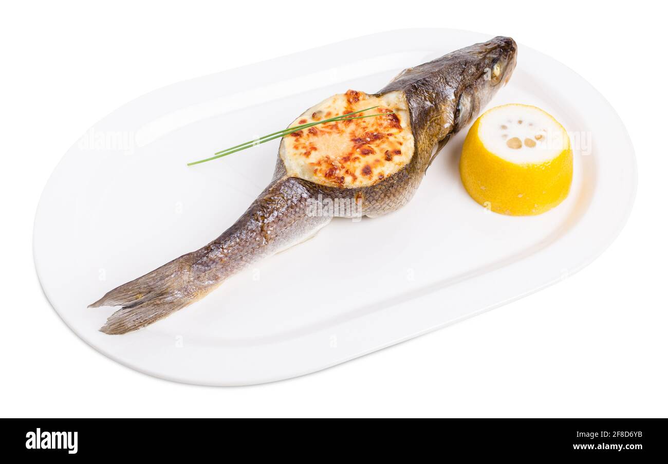 Baked sea bass stuffed with seafood and cheese. Isolated on a white ...