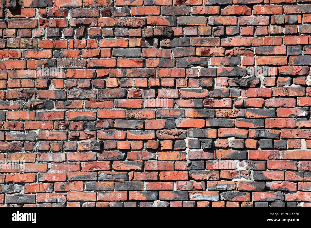 Full frame background red brick wall scorched by fire Stock Photo - Alamy