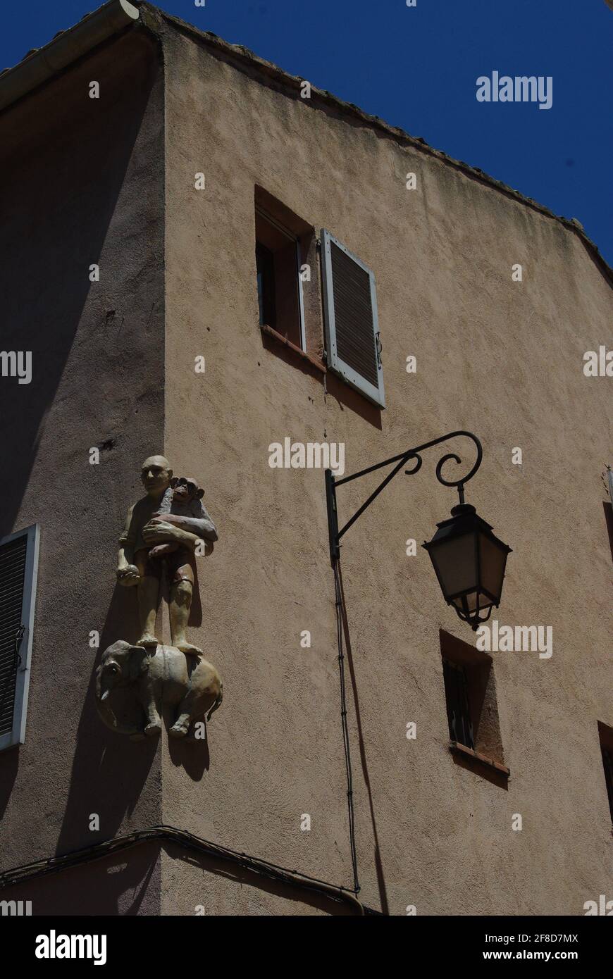Sculptured figures of man and sheep on corner of medieval house in Aix ...