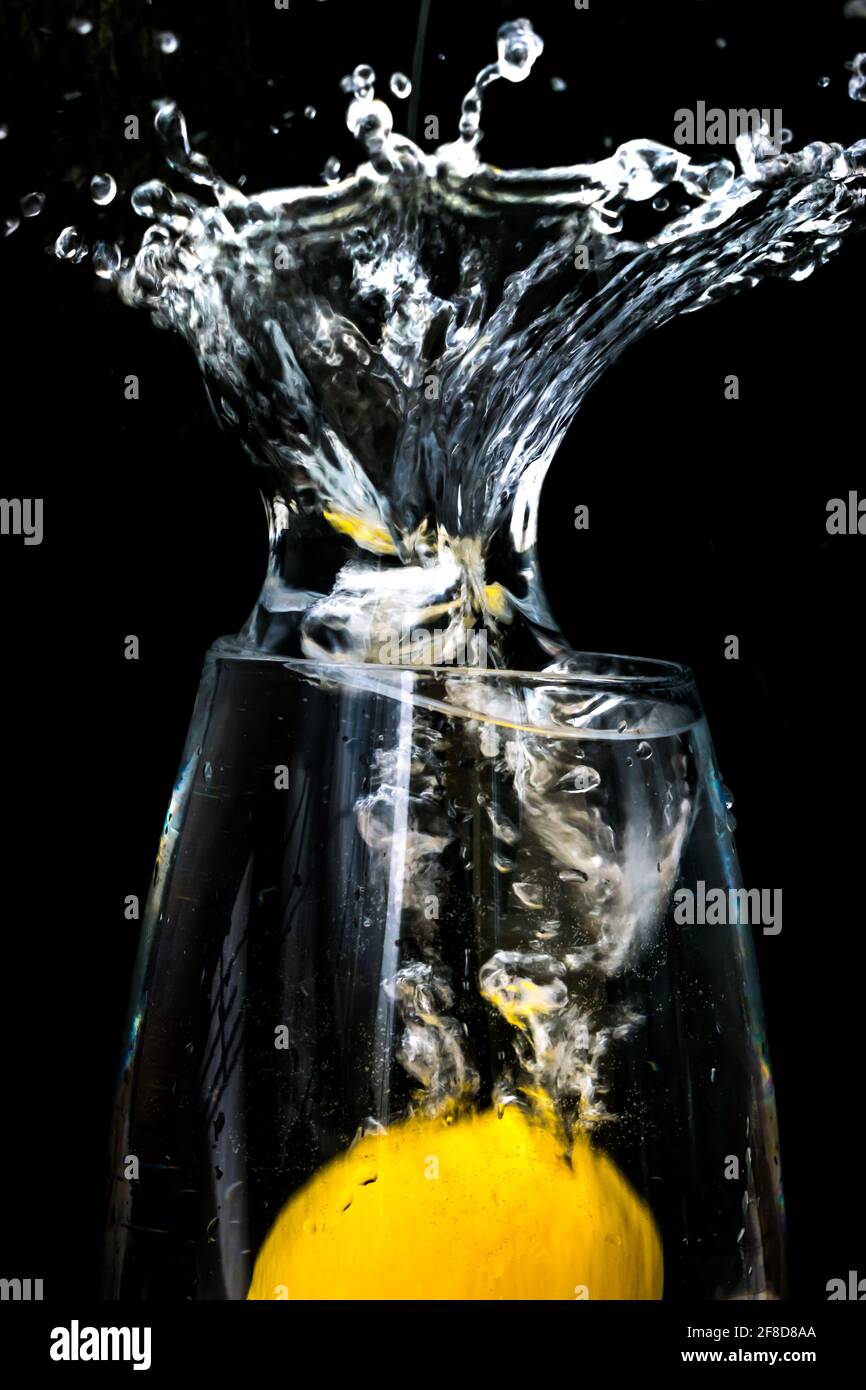 Lemon splashing in water, close-up studio shot Stock Photo - Alamy