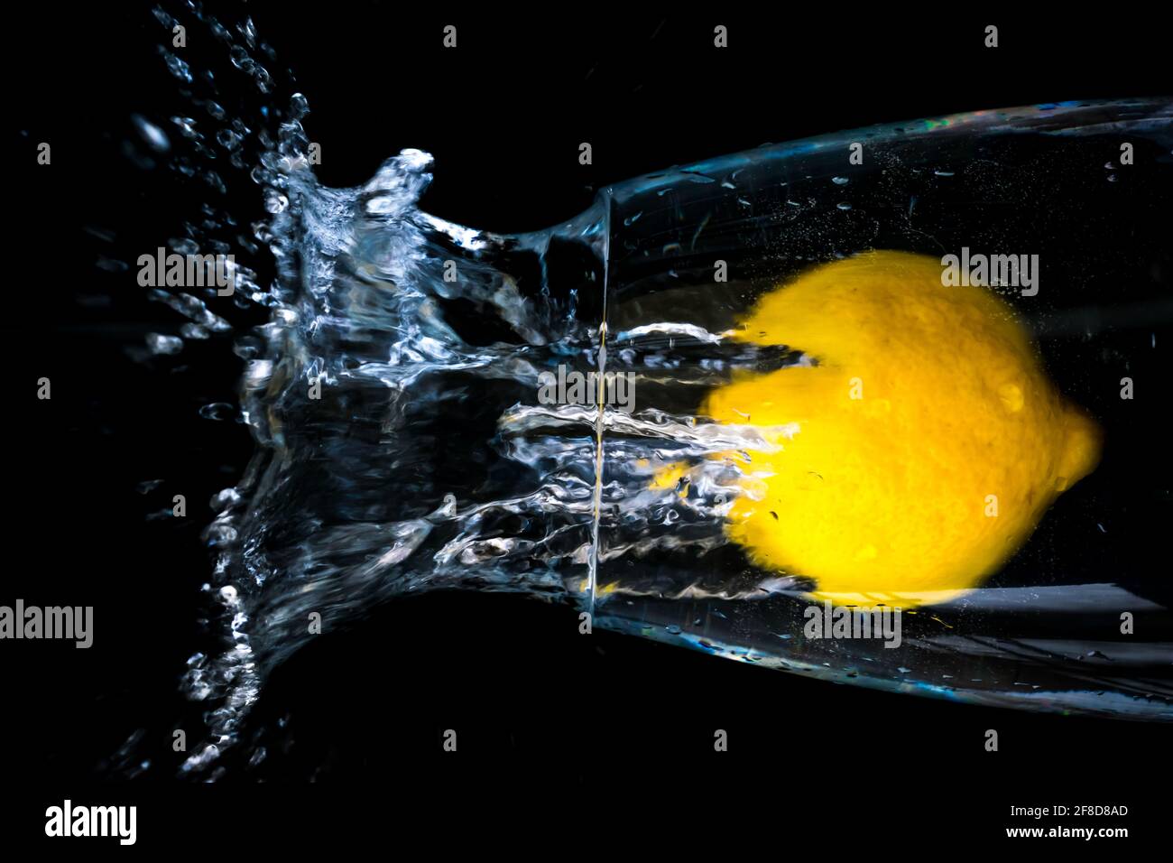 Lemon splashing in water, close-up studio shot Stock Photo - Alamy