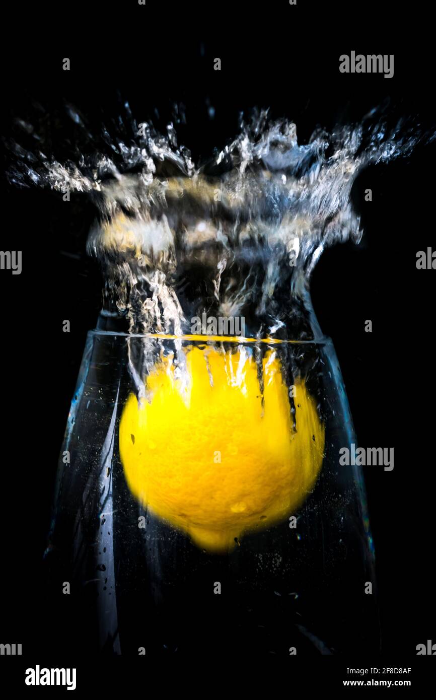 Lemon splashing in water, close-up studio shot Stock Photo - Alamy