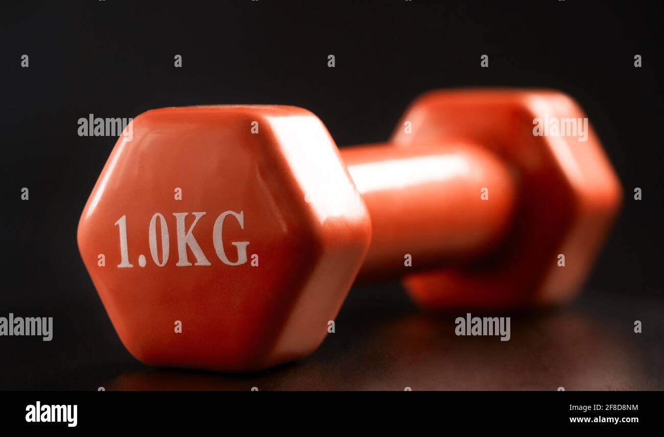One kilogram pink dumbbell on black background Stock Photo - Alamy