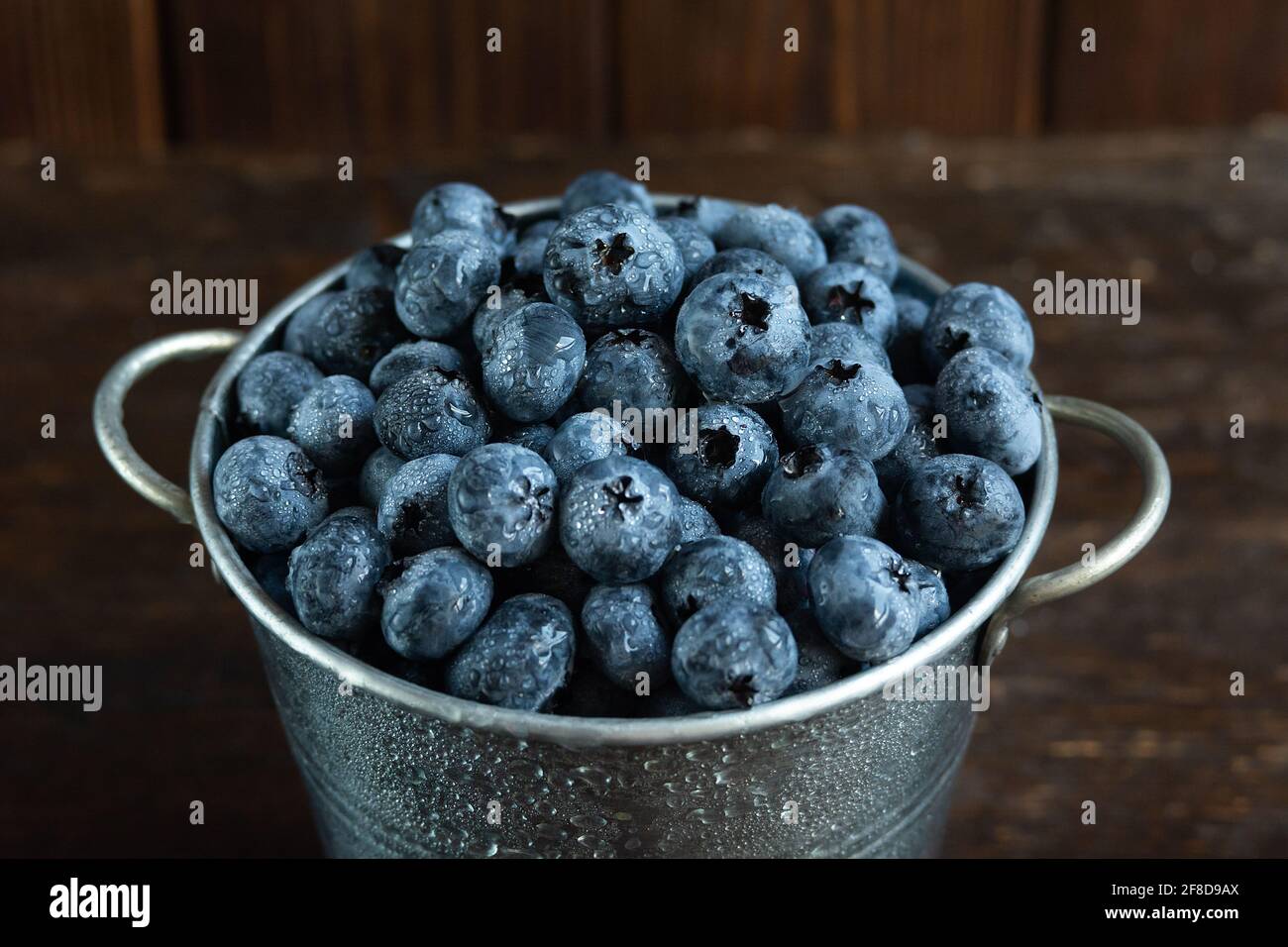 Wet fresh Blueberry background. close up with selective focus and water ...