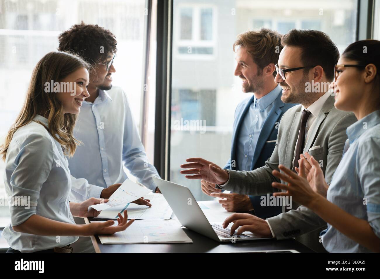 Happy business people having fun and chatting at workplace office Stock ...