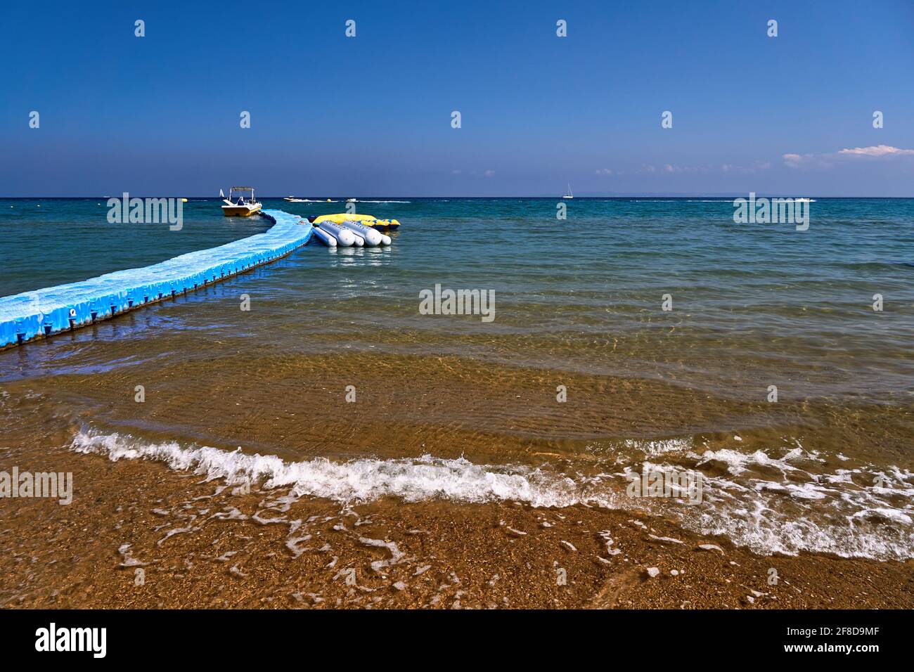 Floating jetty with a motorboat and pontoons on the beach on Zakynthos ...