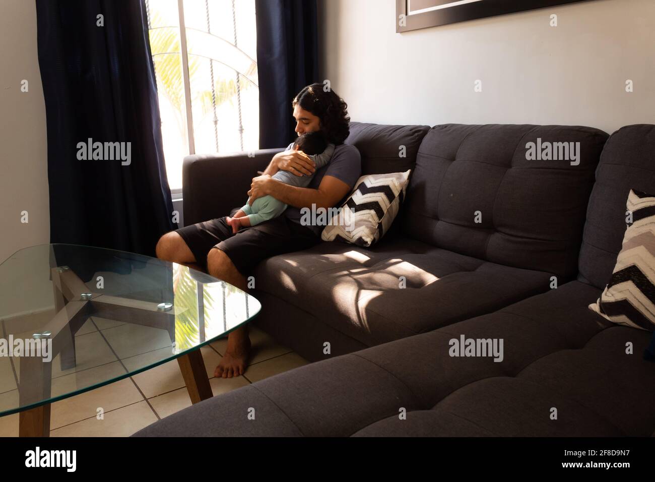 young happy hispanic father hugging and holding his newborn baby Stock ...