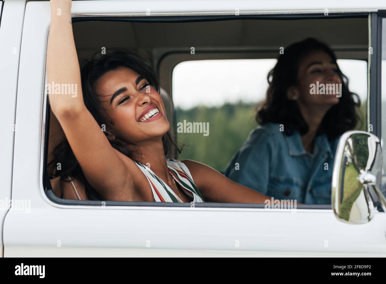 Young laughing woman putting her hand out of a car having fun Stock ...