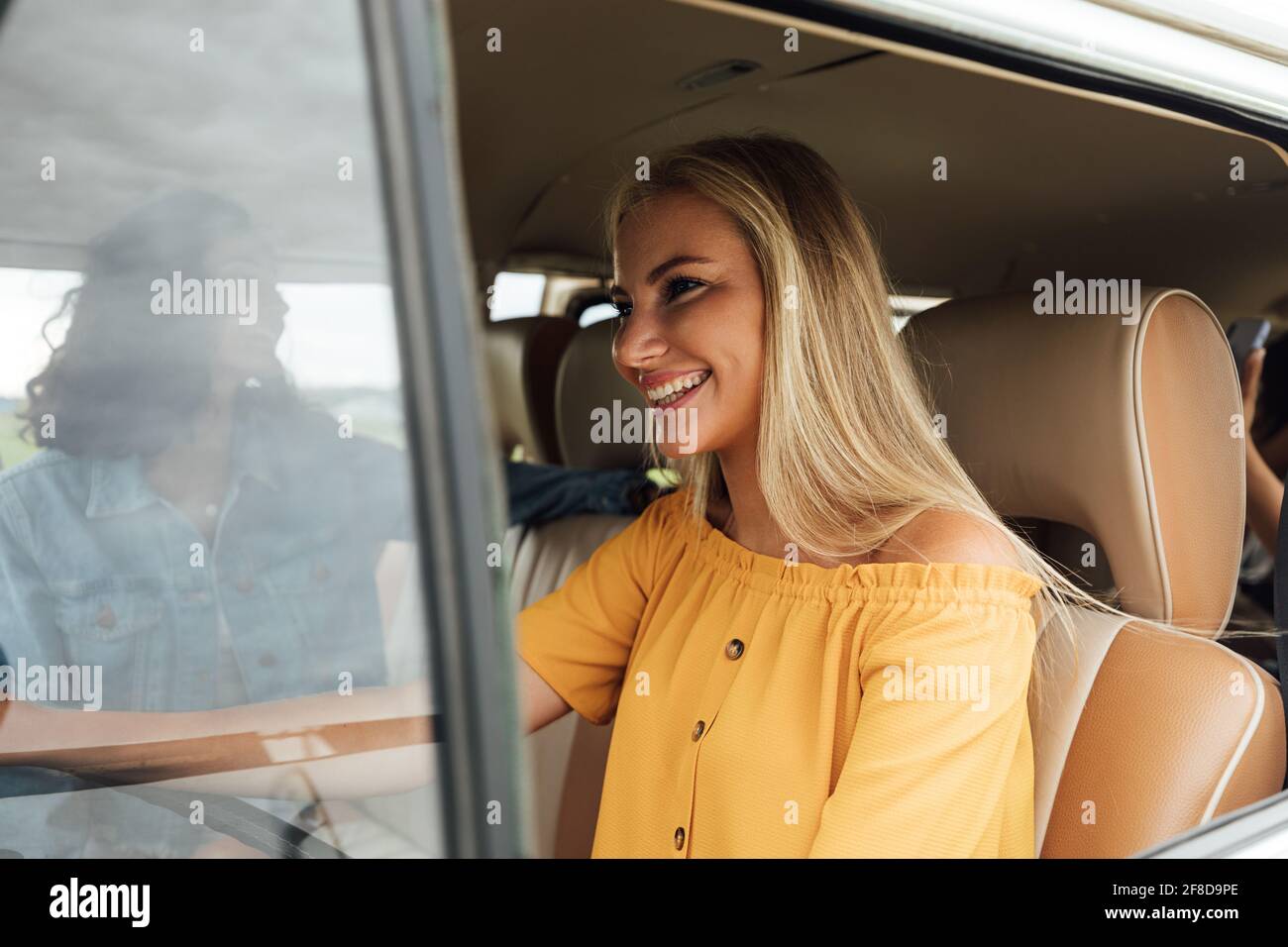 Smiling blond woman driving a camper van going on a road trip Stock ...