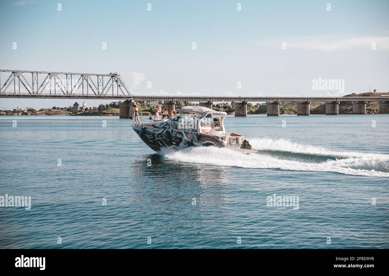 yacht at speed floats on water against the background of the bridge ...