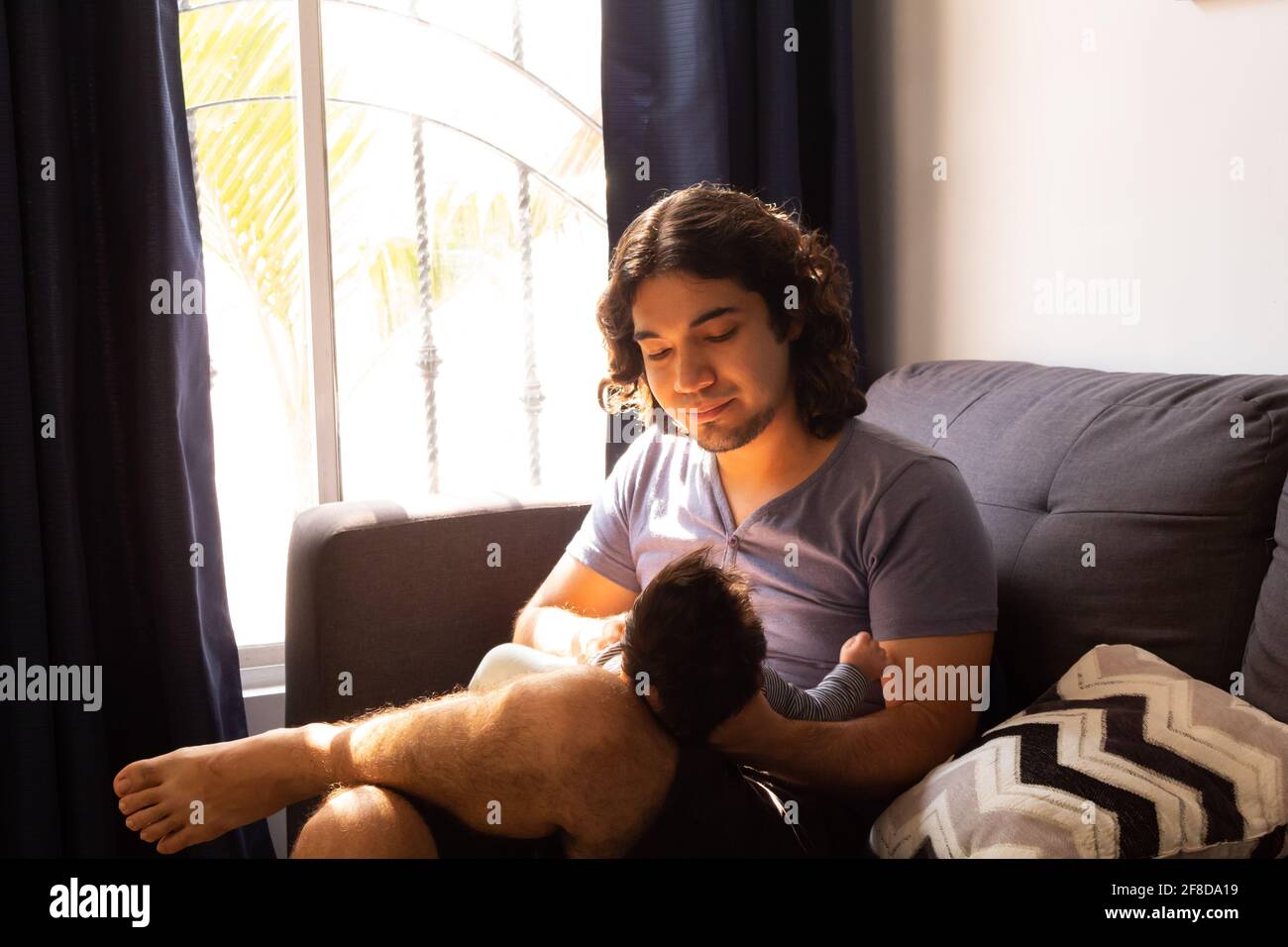 young happy hispanic father hugging and holding his newborn baby Stock ...