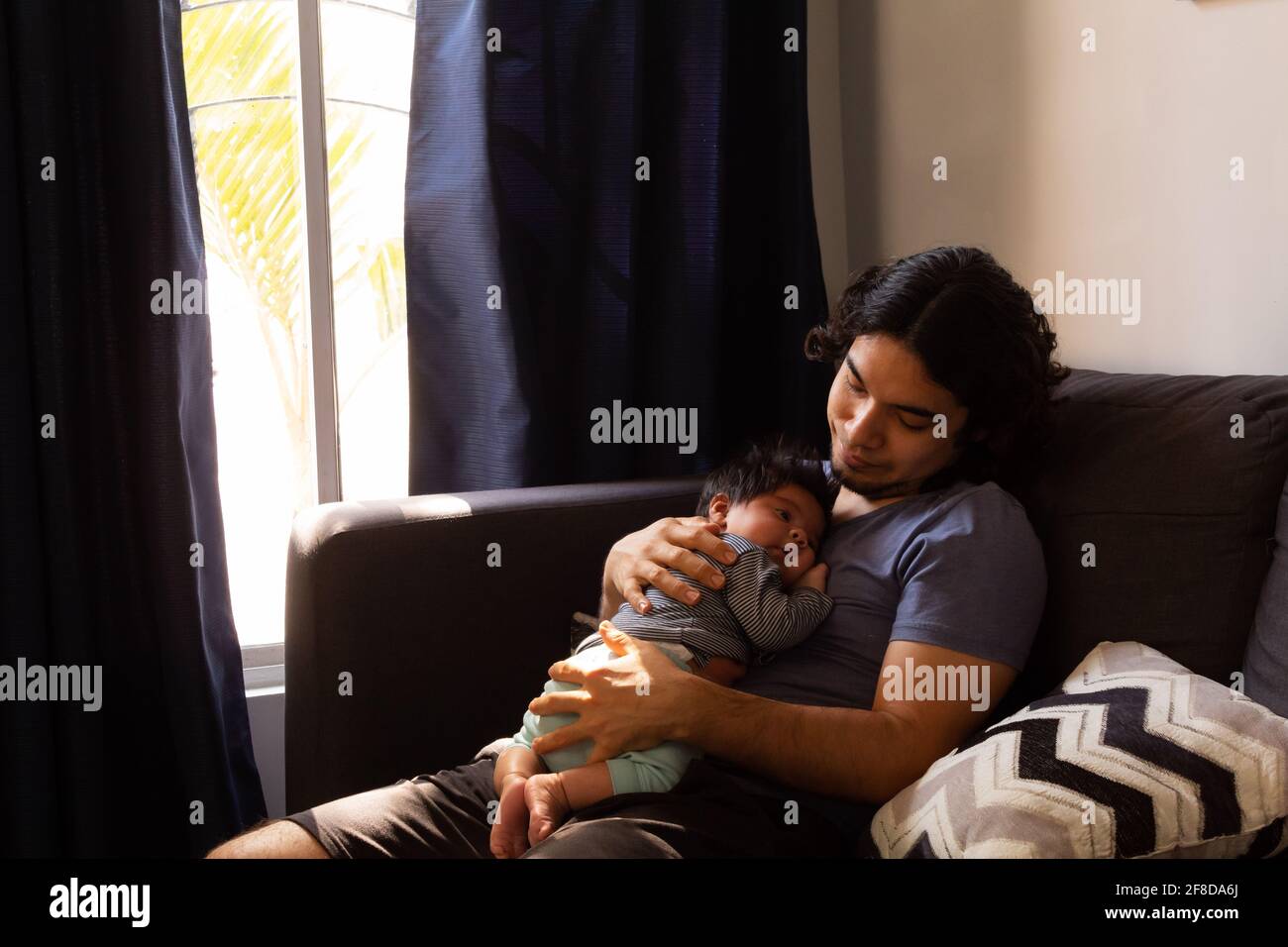 young happy hispanic father hugging and holding his newborn baby Stock ...
