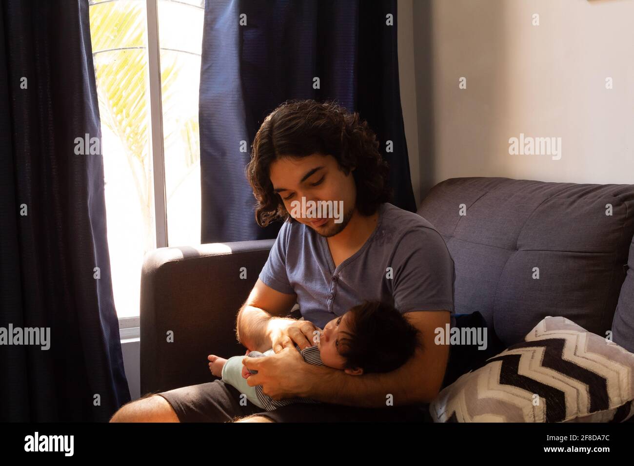 young happy hispanic father hugging and holding his newborn baby Stock ...