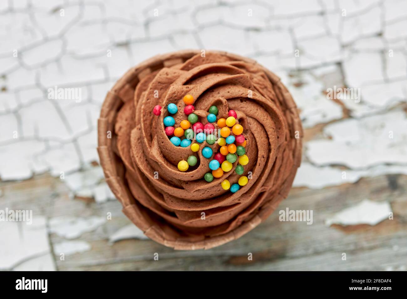 Aerial view of a chocolate cupcake with colored candies Stock Photo - Alamy
