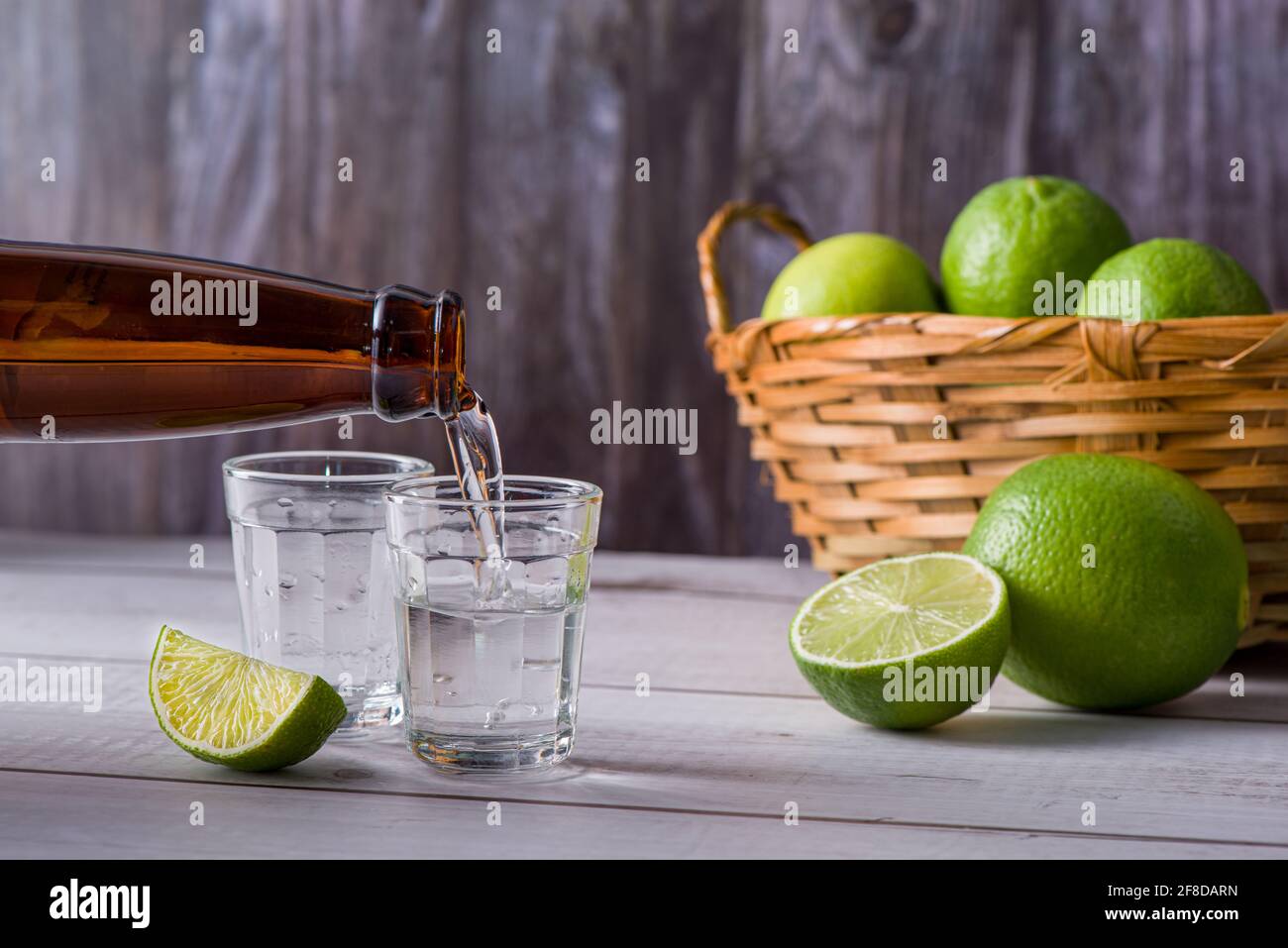 Bottle of pouring sugarcane liquor, a strong typical Brazilian ...
