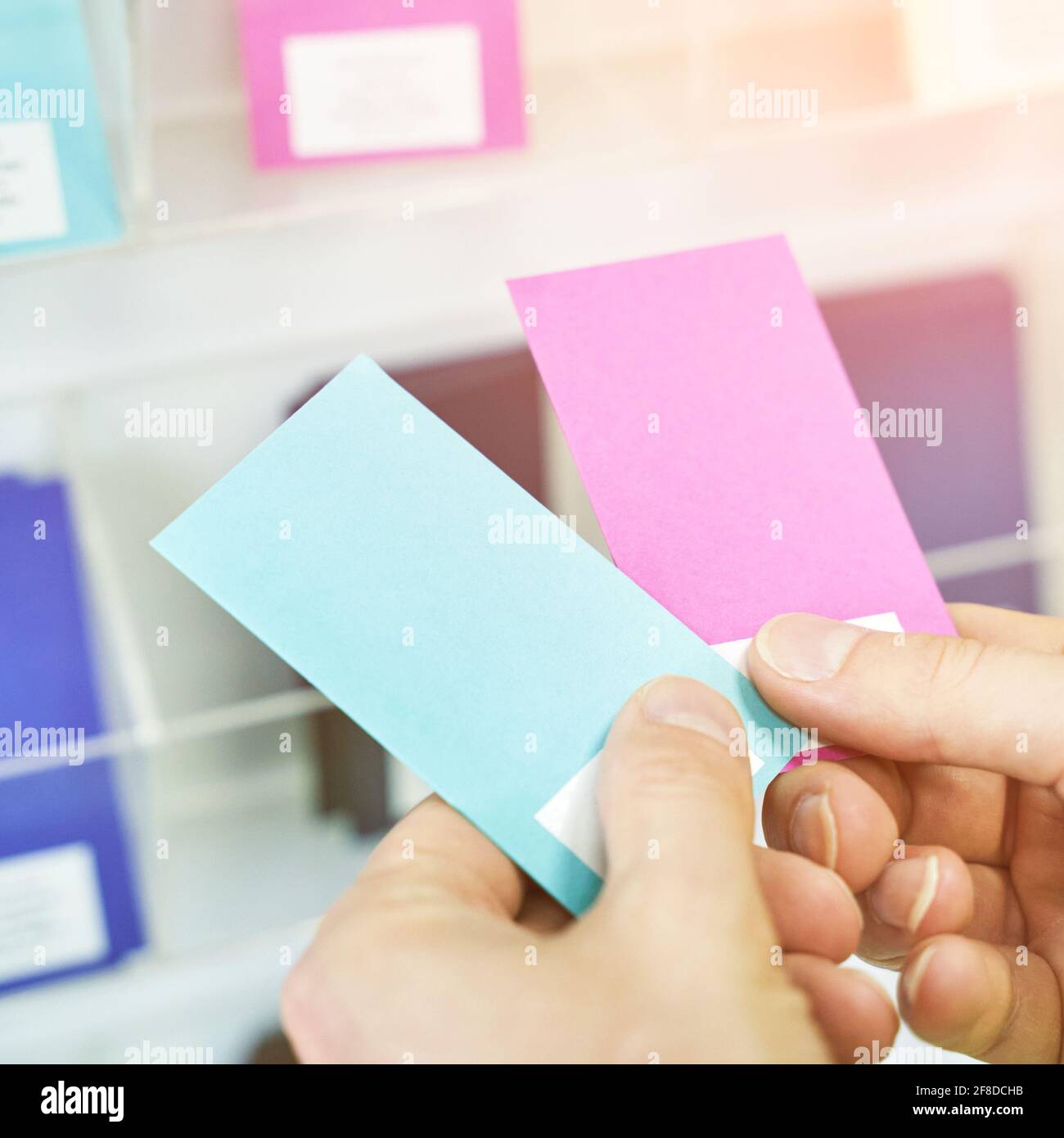 Choosing wall color sample. Man hands holding paper example. Blue or ...