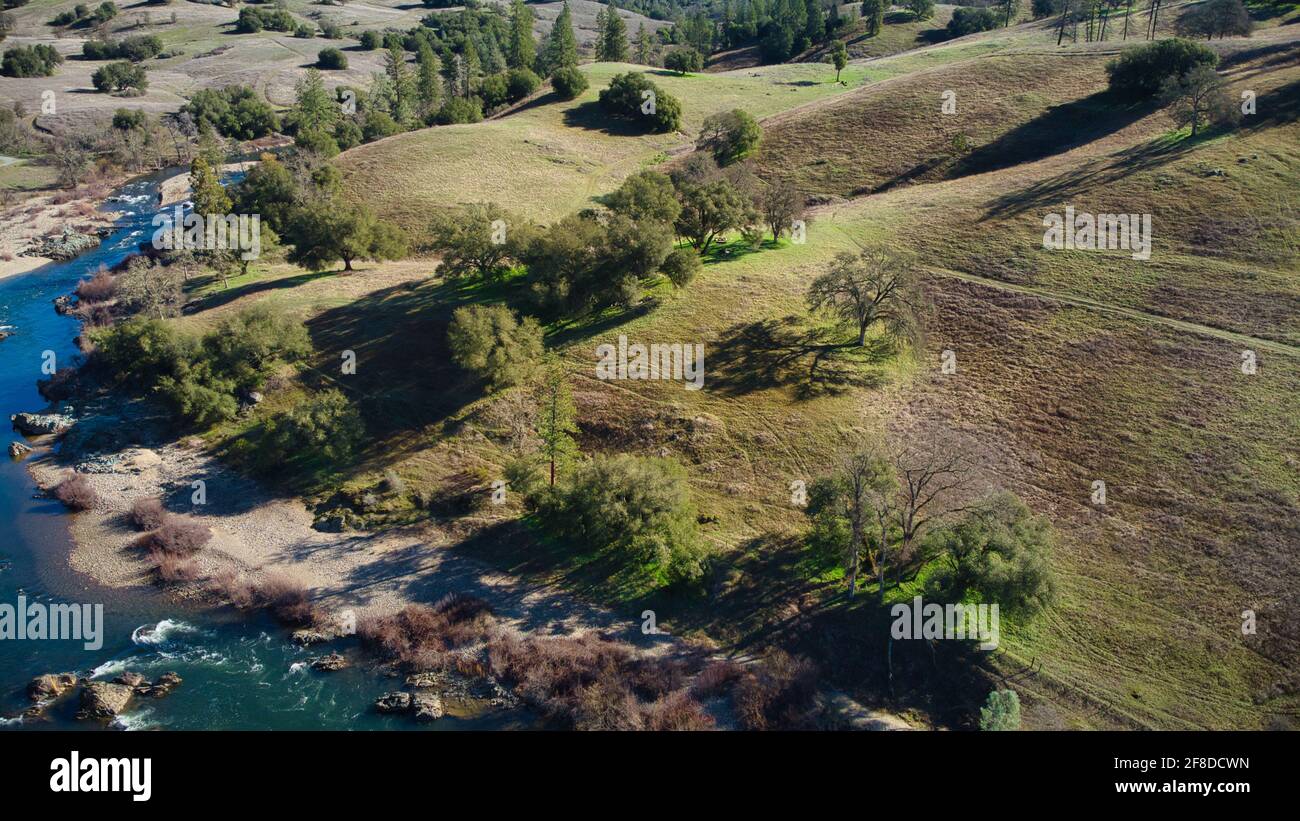 Aerial view of a hilly green lakeshore on a sunny day Stock Photo - Alamy