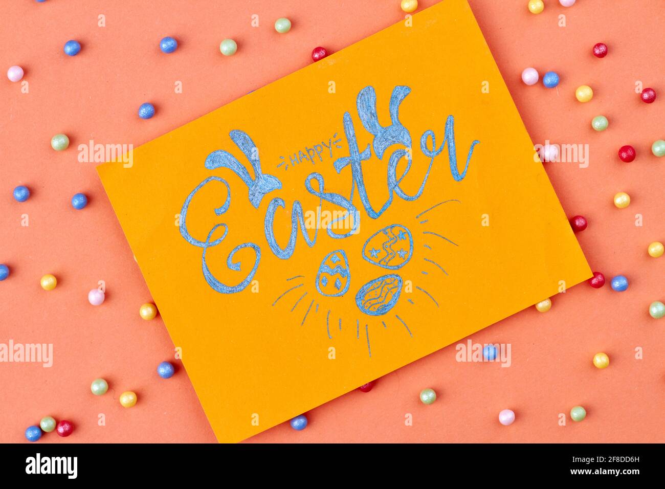 Yellow paper with happy easter wish Stock Photo - Alamy
