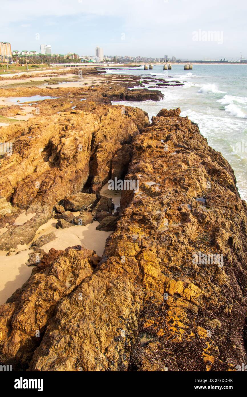 Port Elizabeth, South Africa - small waves break against the rocks at ...