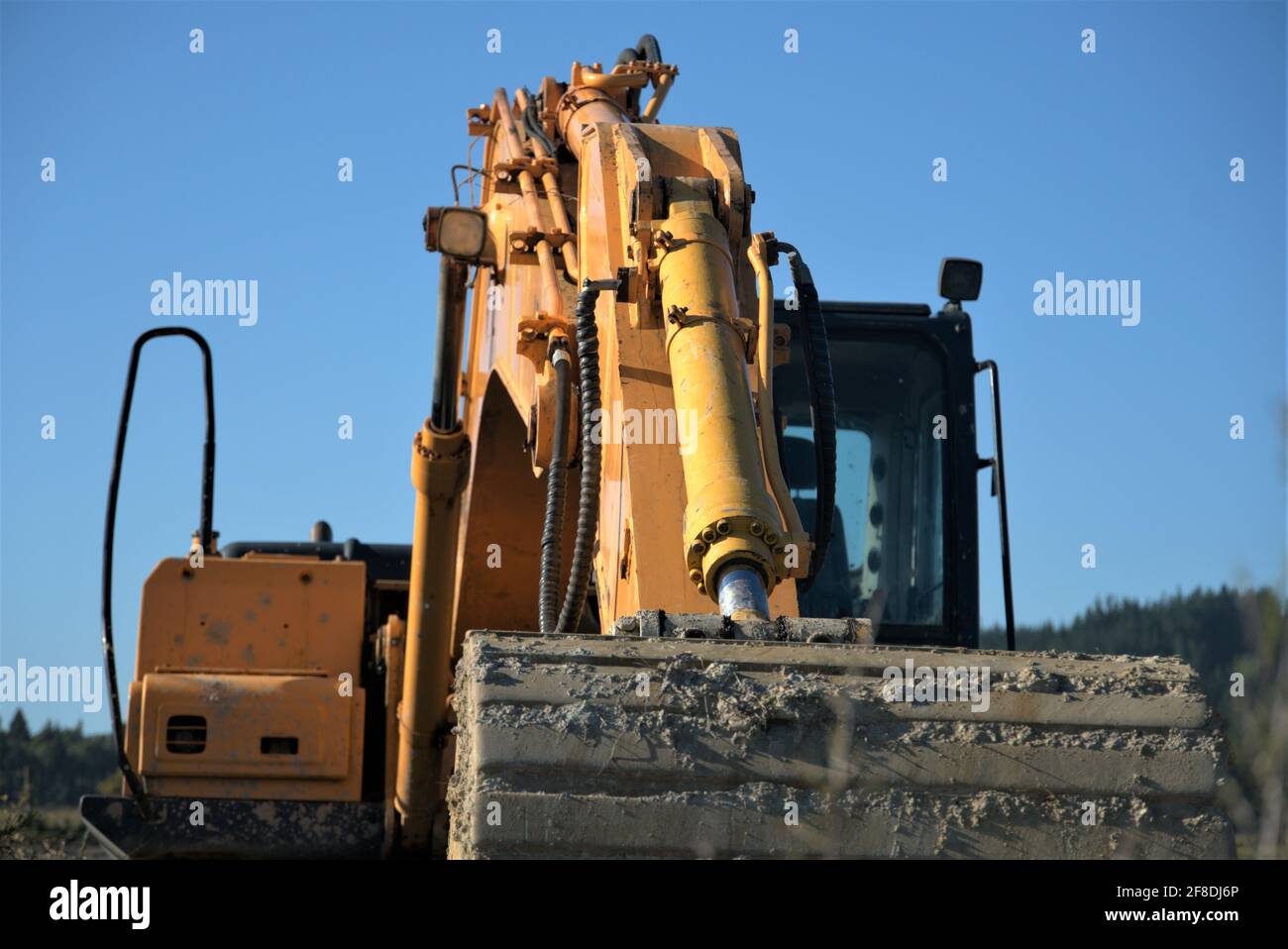 Excavator growing in an agricultural field Stock Photo - Alamy
