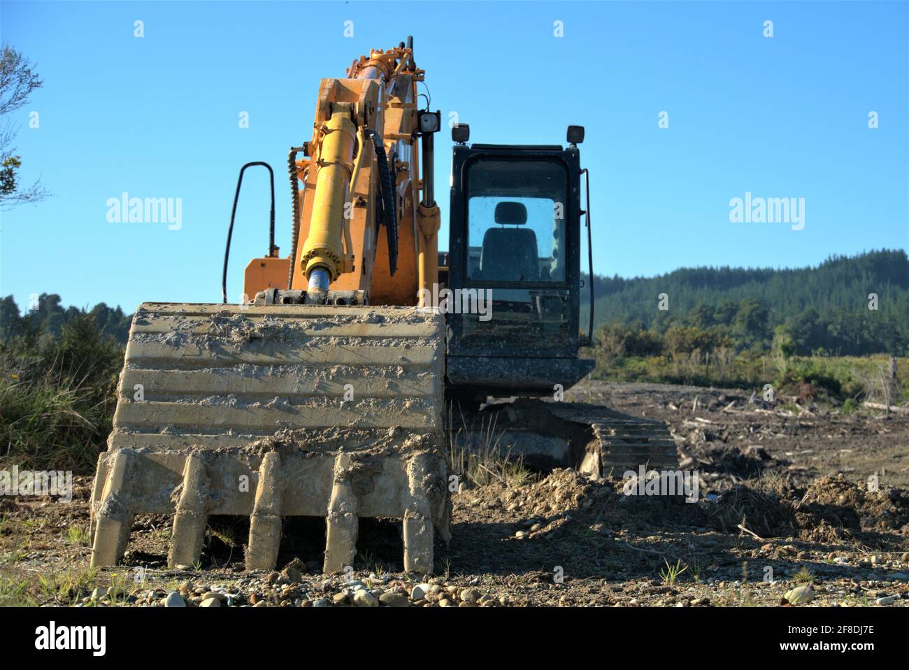 Excavator growing in an agricultural field Stock Photo - Alamy