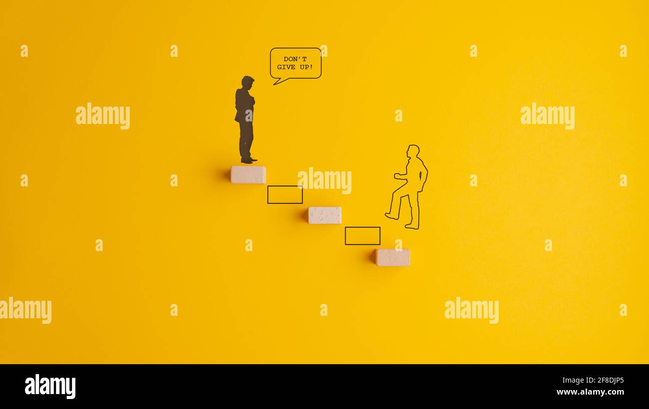 Silhouette of a man climbing up the stairway towards a Dont give up ...