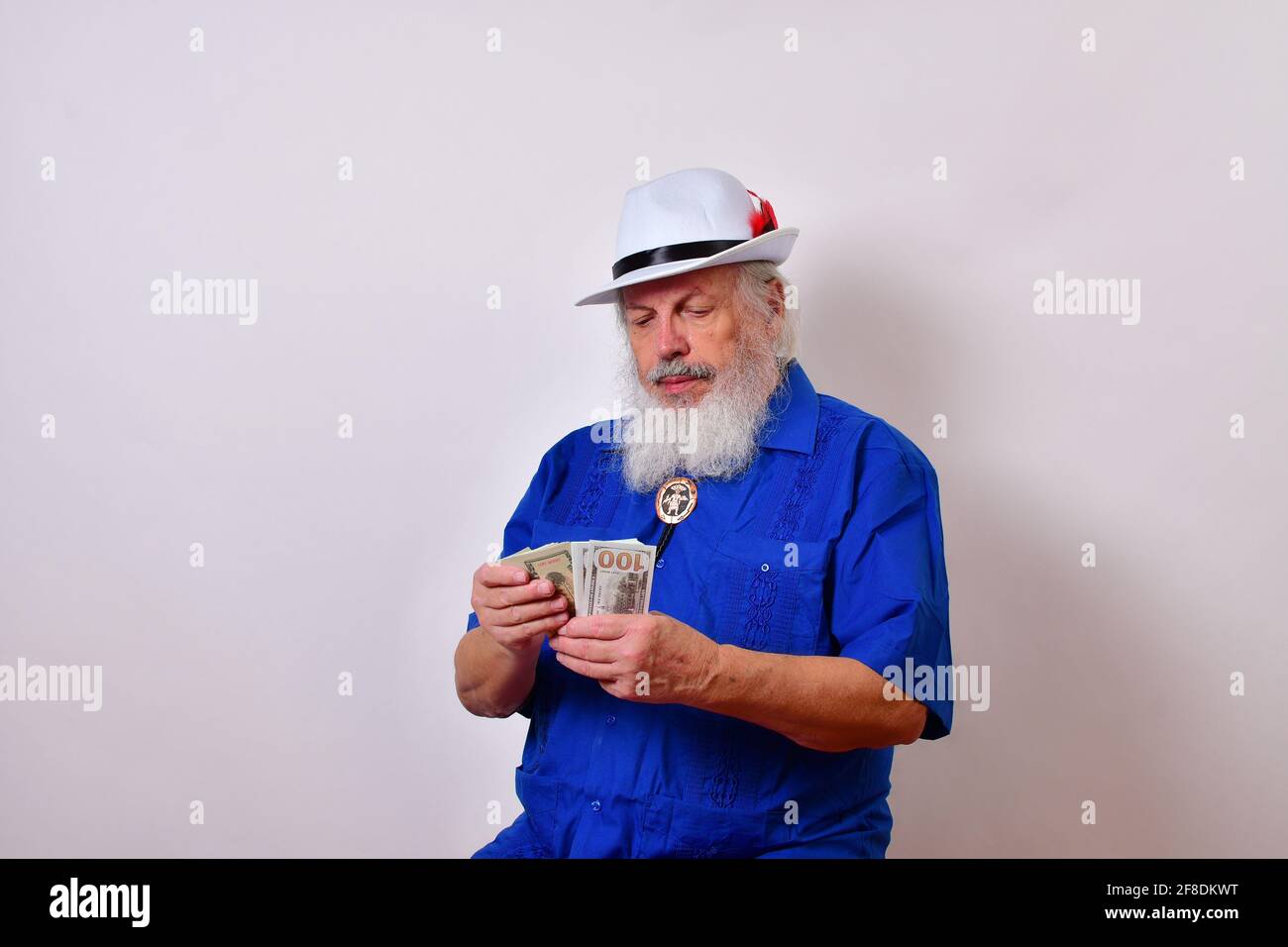 A rich old man counting a handful of paper bills Stock Photo - Alamy
