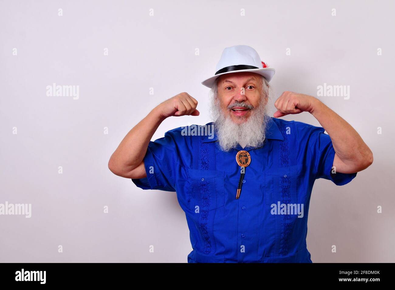 Mature gentleman with a white fedora hat, blue guayabera shirt, and ...