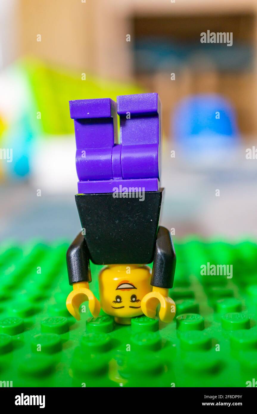 POZNAN, POLAND - Mar 27, 2021: Lego woman figurine doing a handstand ...