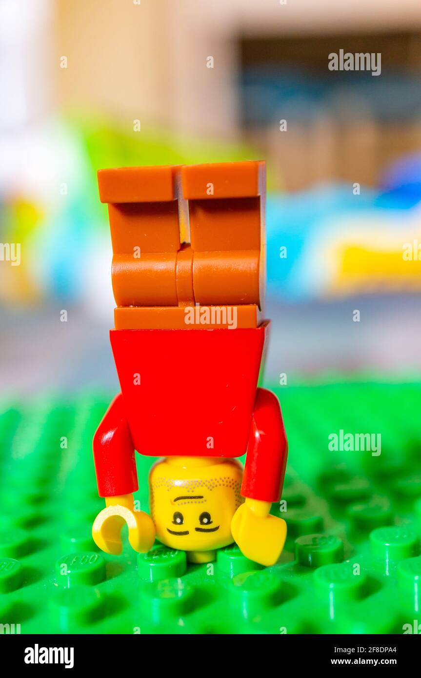 POZNAN, POLAND - Mar 27, 2021: One Lego man figurine doing a handstand ...