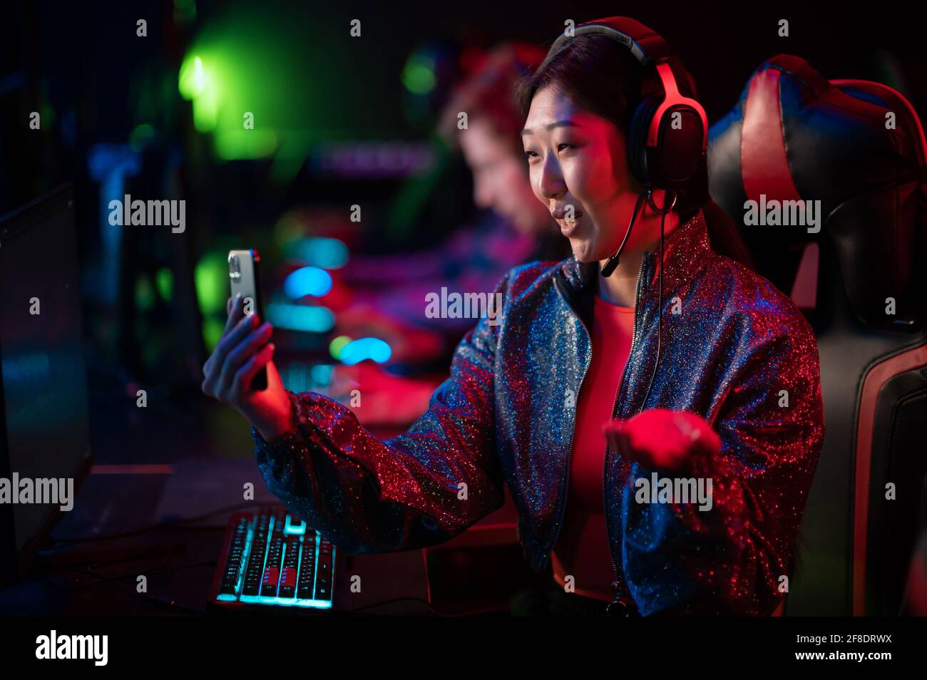 A pretty streamer girl is broadcasting on twitch from a dota tournament ...