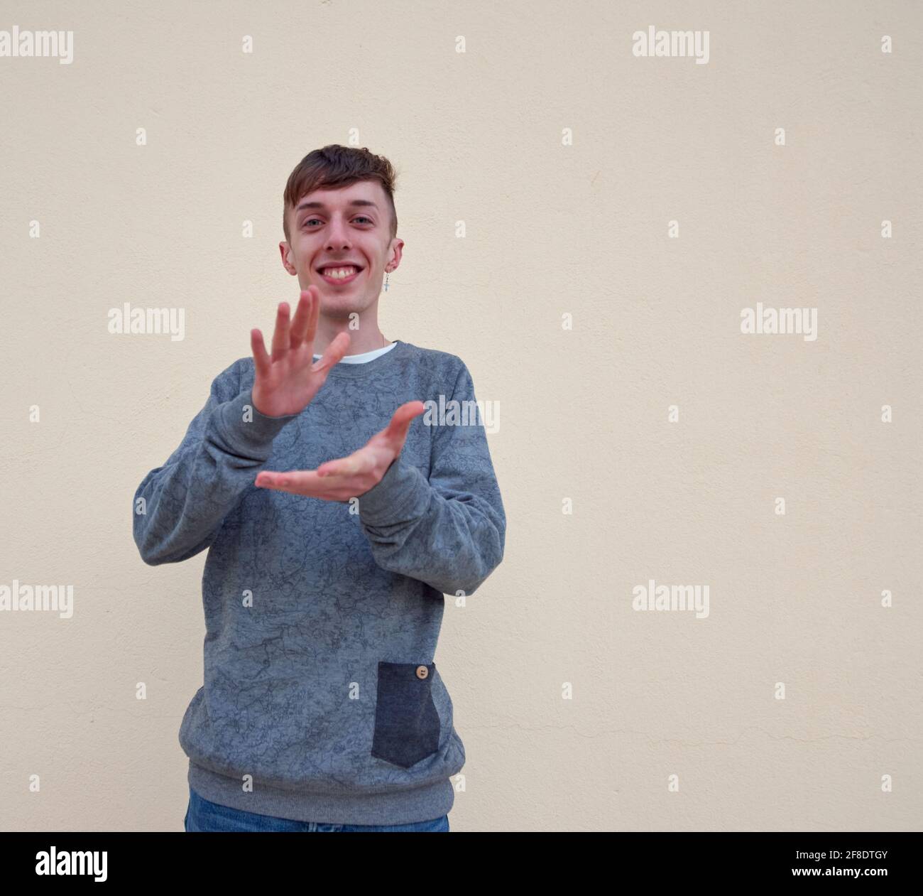 Cheerful Caucasian male from Spain standing and clapping hands on a ...