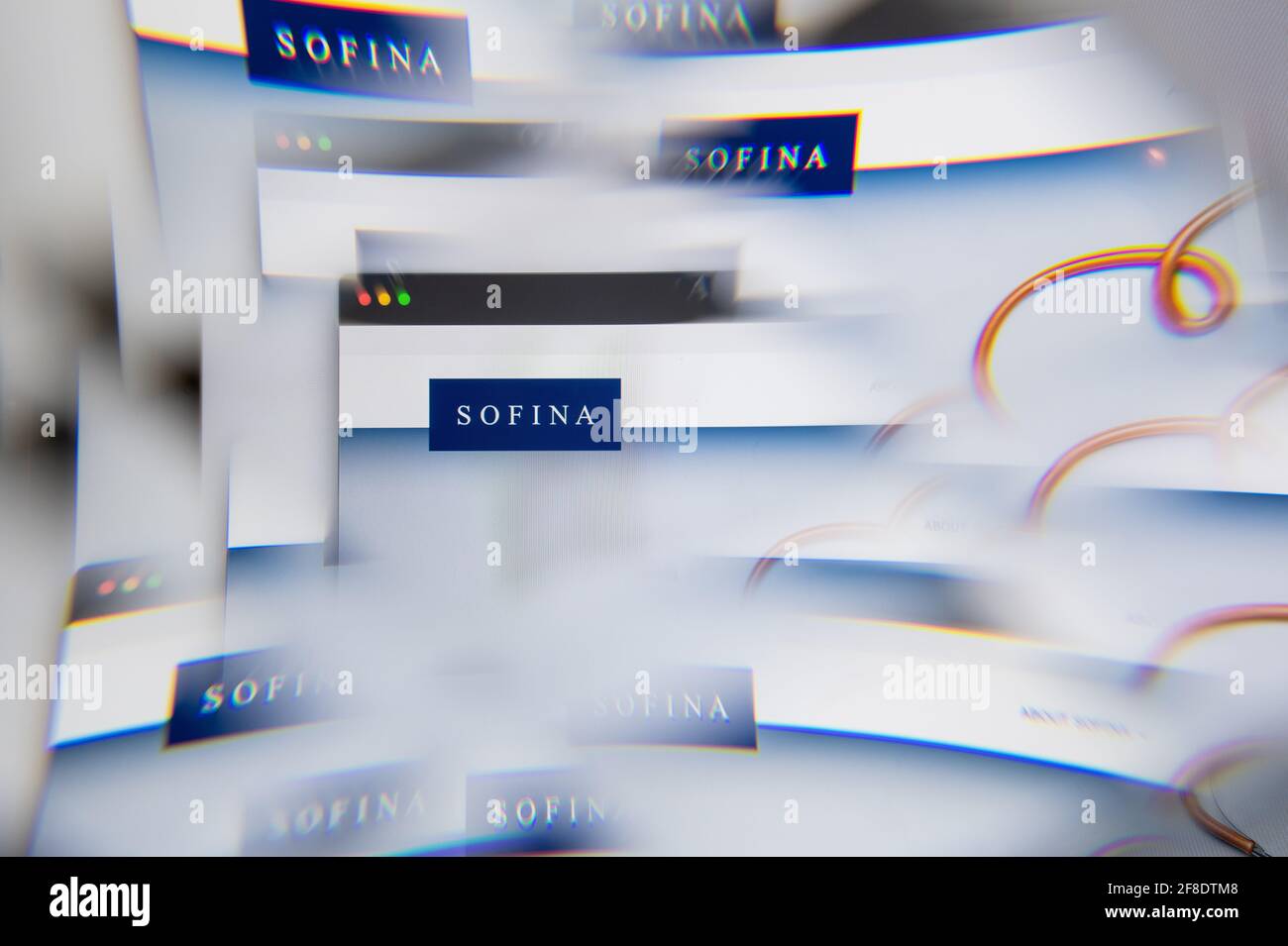 Milan, Italy - APRIL 10, 2021: Sofina logo on laptop screen seen through an optical prism ...
