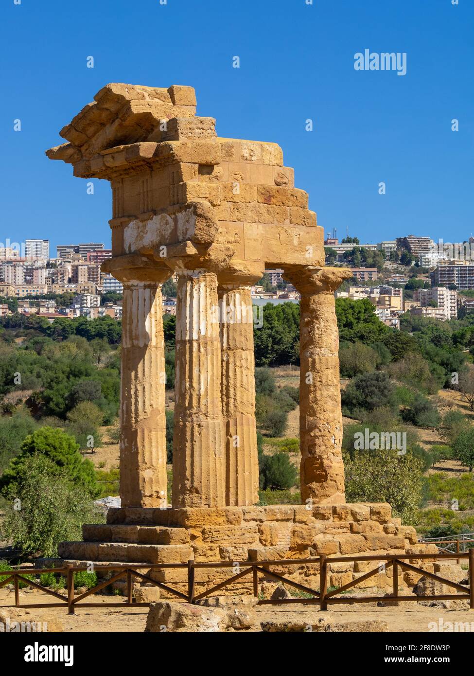 Temple of Castor and Pollux remains with Agrigento city in background ...